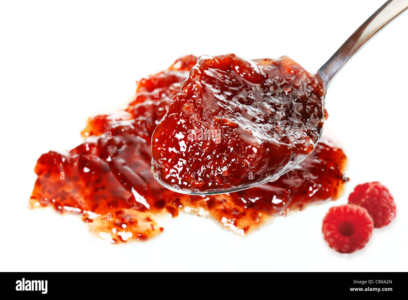 Raspberry jam with a spoon Stock Photo - Alamy