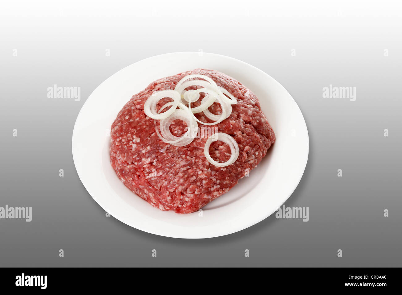 Minced meat, half ground beef, half ground pork, with onion rings, on a ...