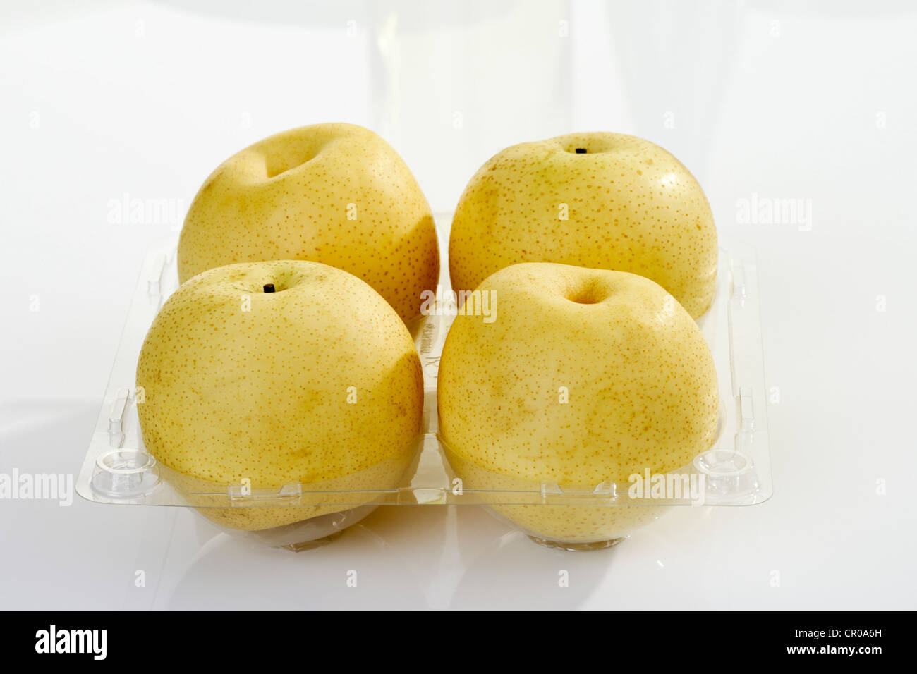 Four Asian pears on plastic tray Stock Photo - Alamy