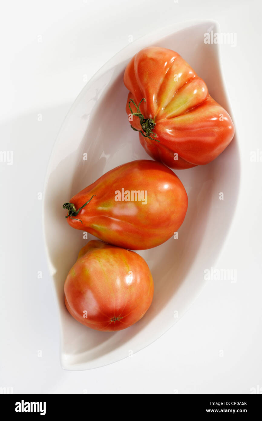 Giant Ox Heart tomatoes on porcelain dish Stock Photo - Alamy
