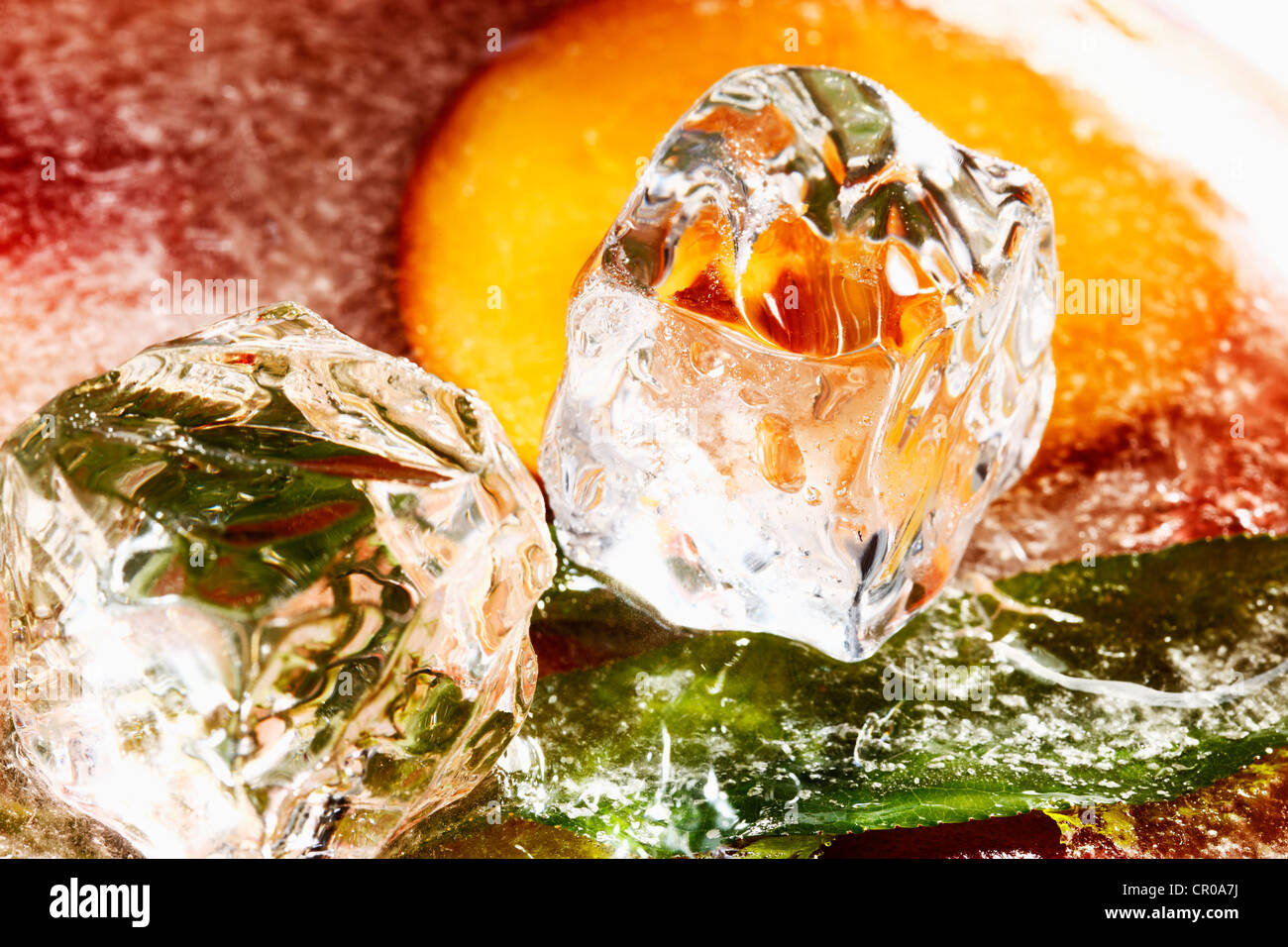 Ice cubes on a block of ice with frozen peaches Stock Photo - Alamy