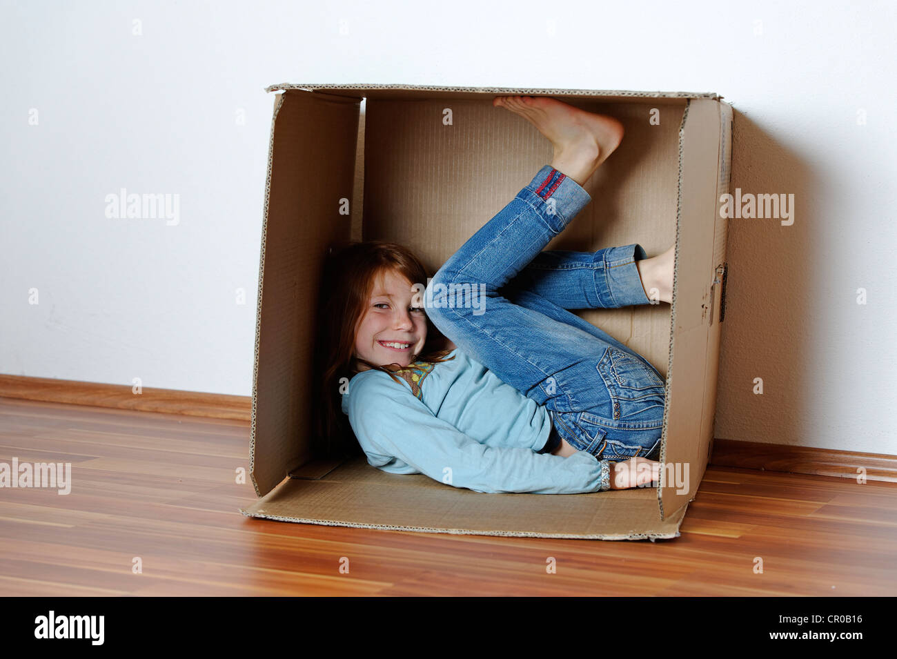 Girl playing in an empty cardboard box Stock Photo - Alamy