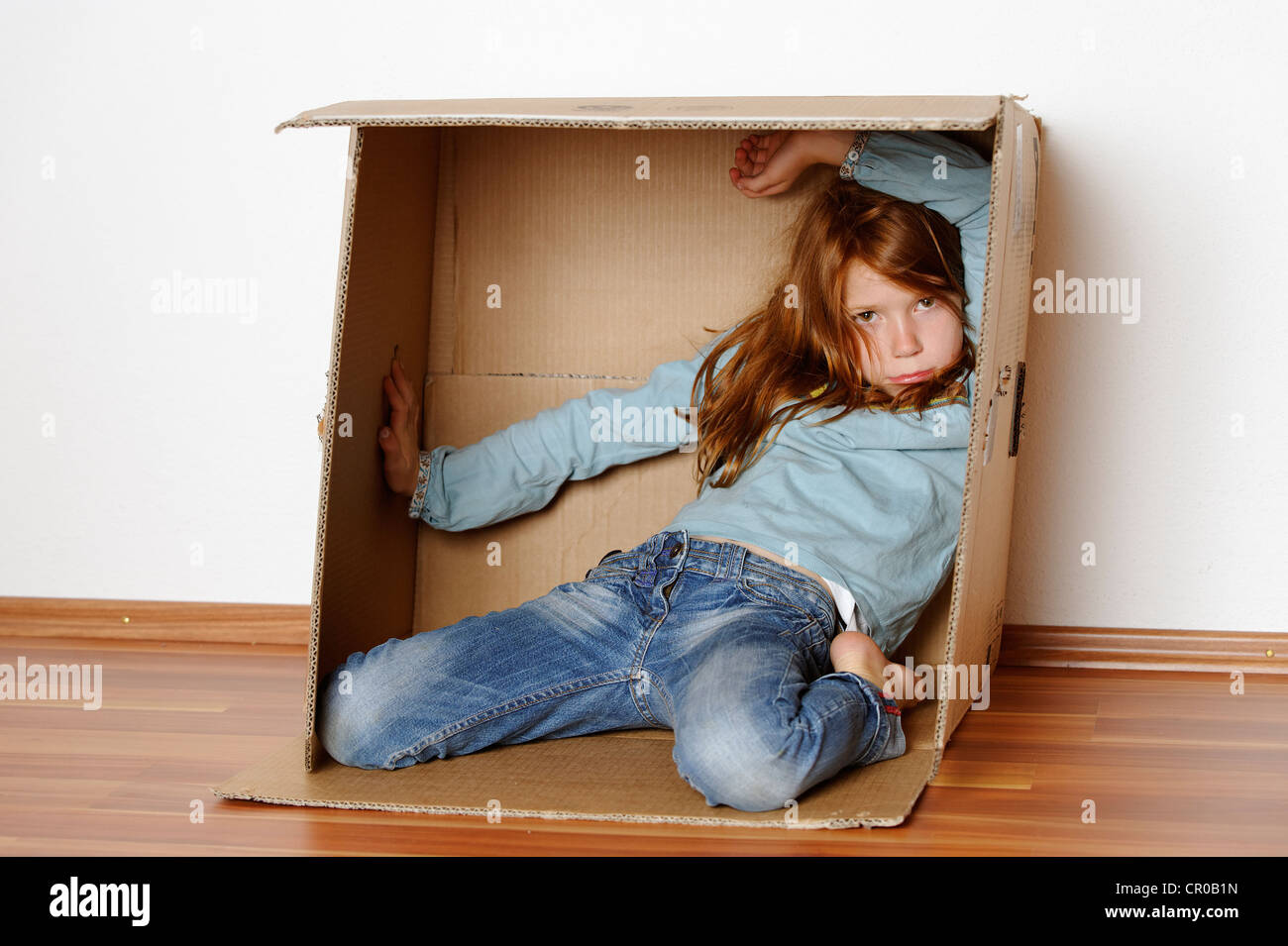 Girl playing in an empty cardboard box Stock Photo - Alamy