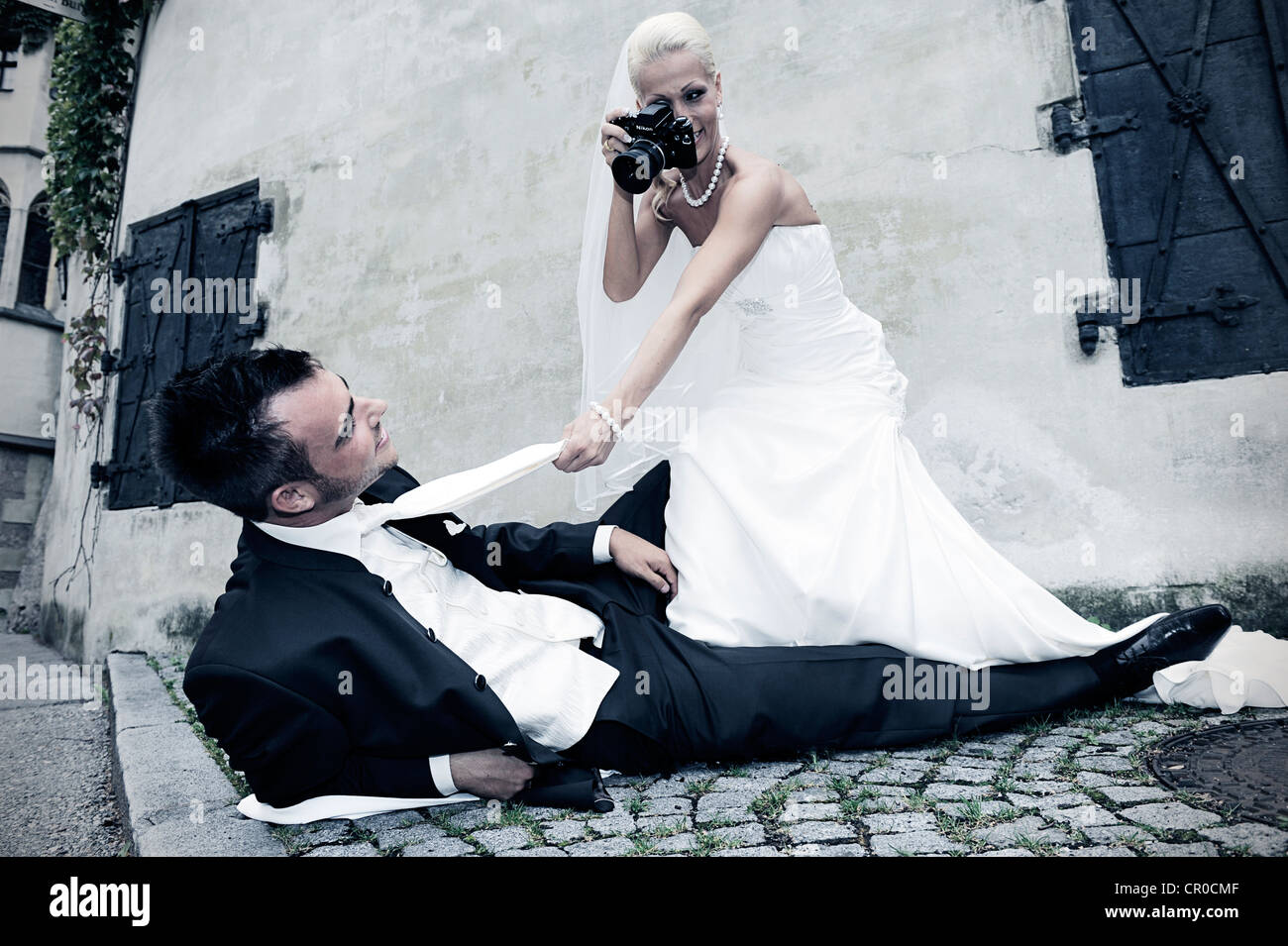 Bride photographing the groom with an old camera, photo shoot, wedding ...