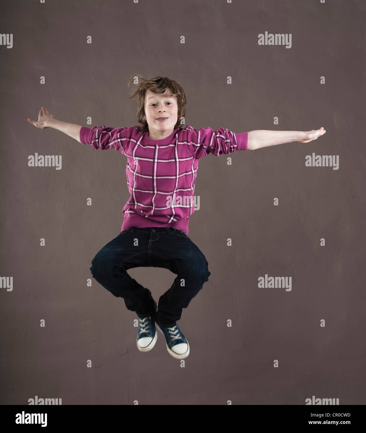 Boy leaping into the air Stock Photo - Alamy