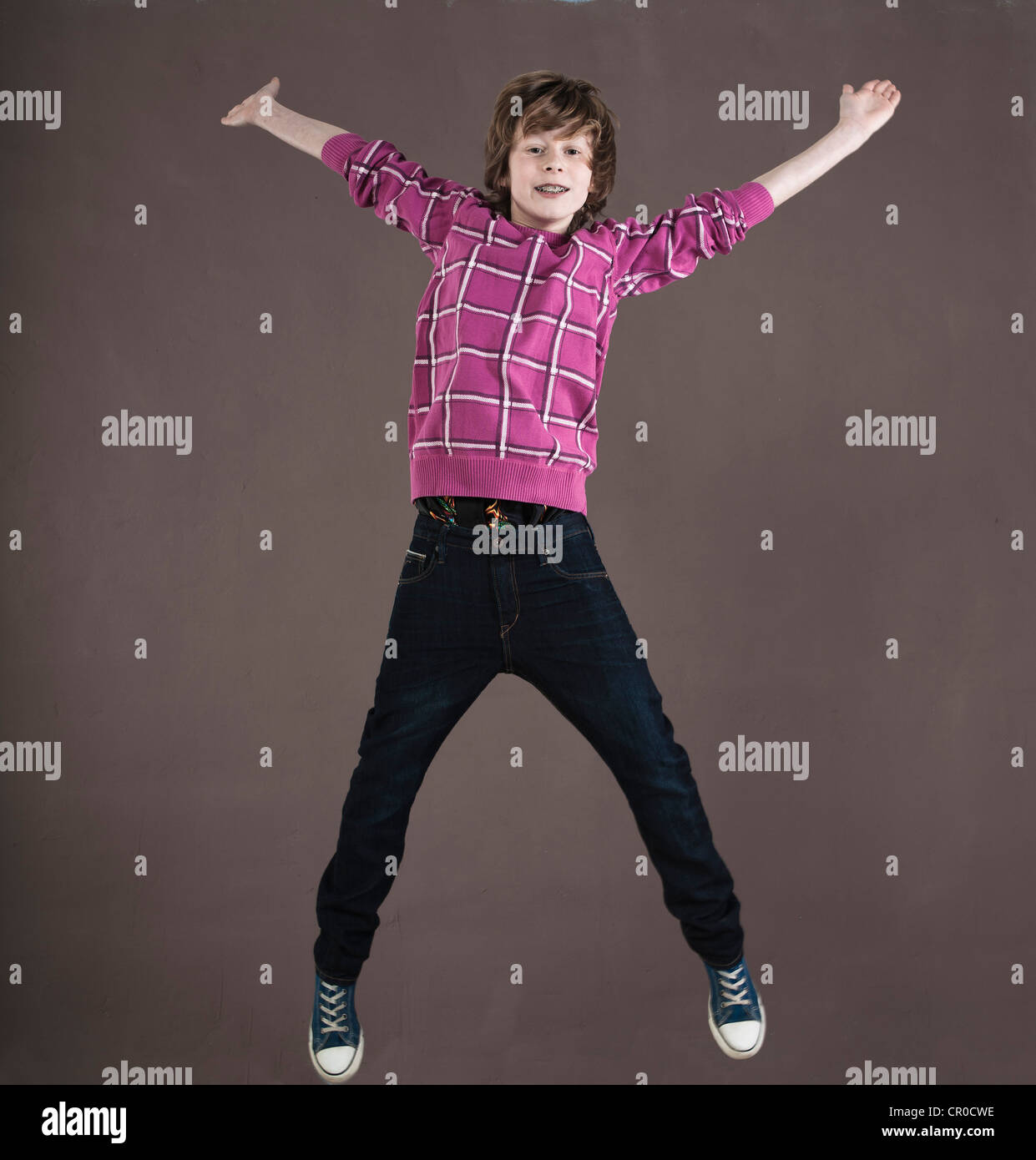 Boy leaping into the air Stock Photo - Alamy