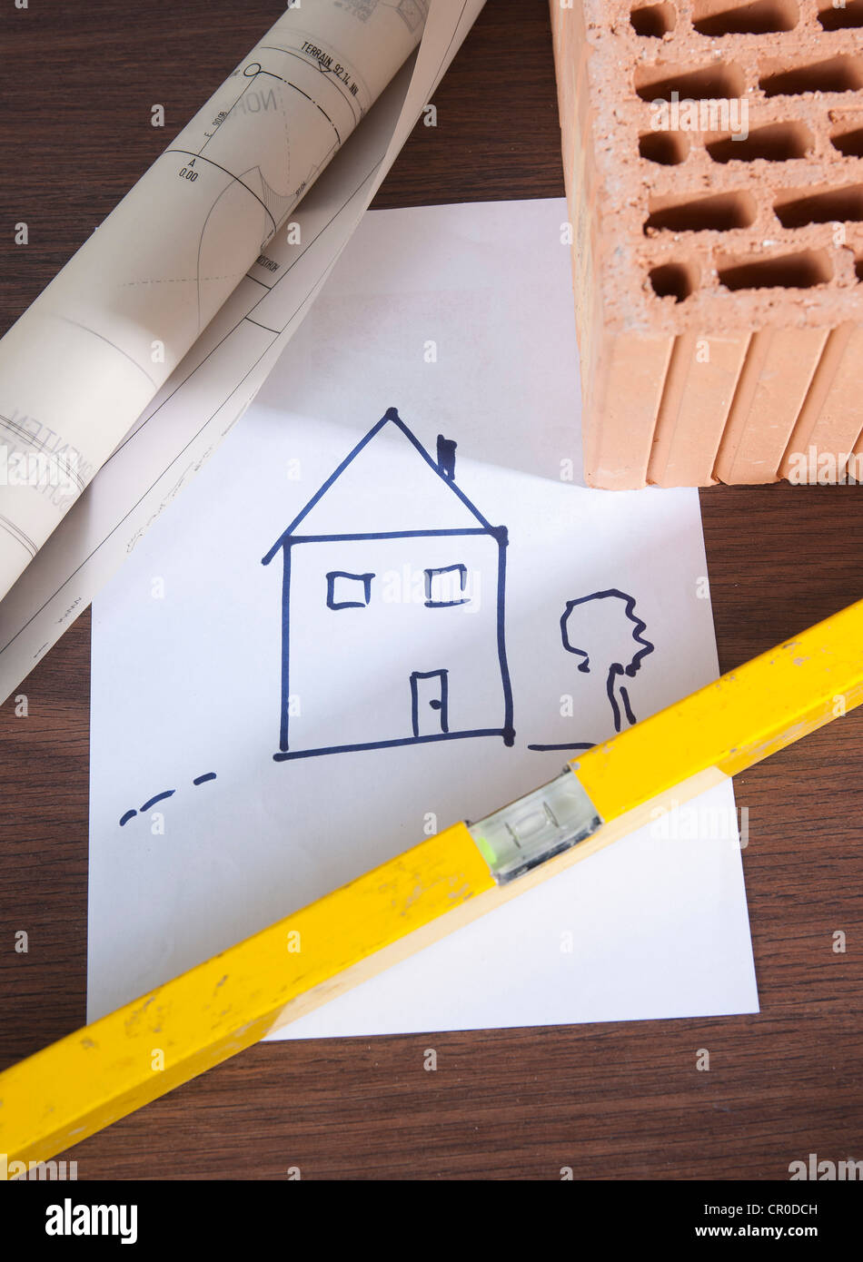 Building plan, spirit level and a brick on a drawing of a house Stock ...