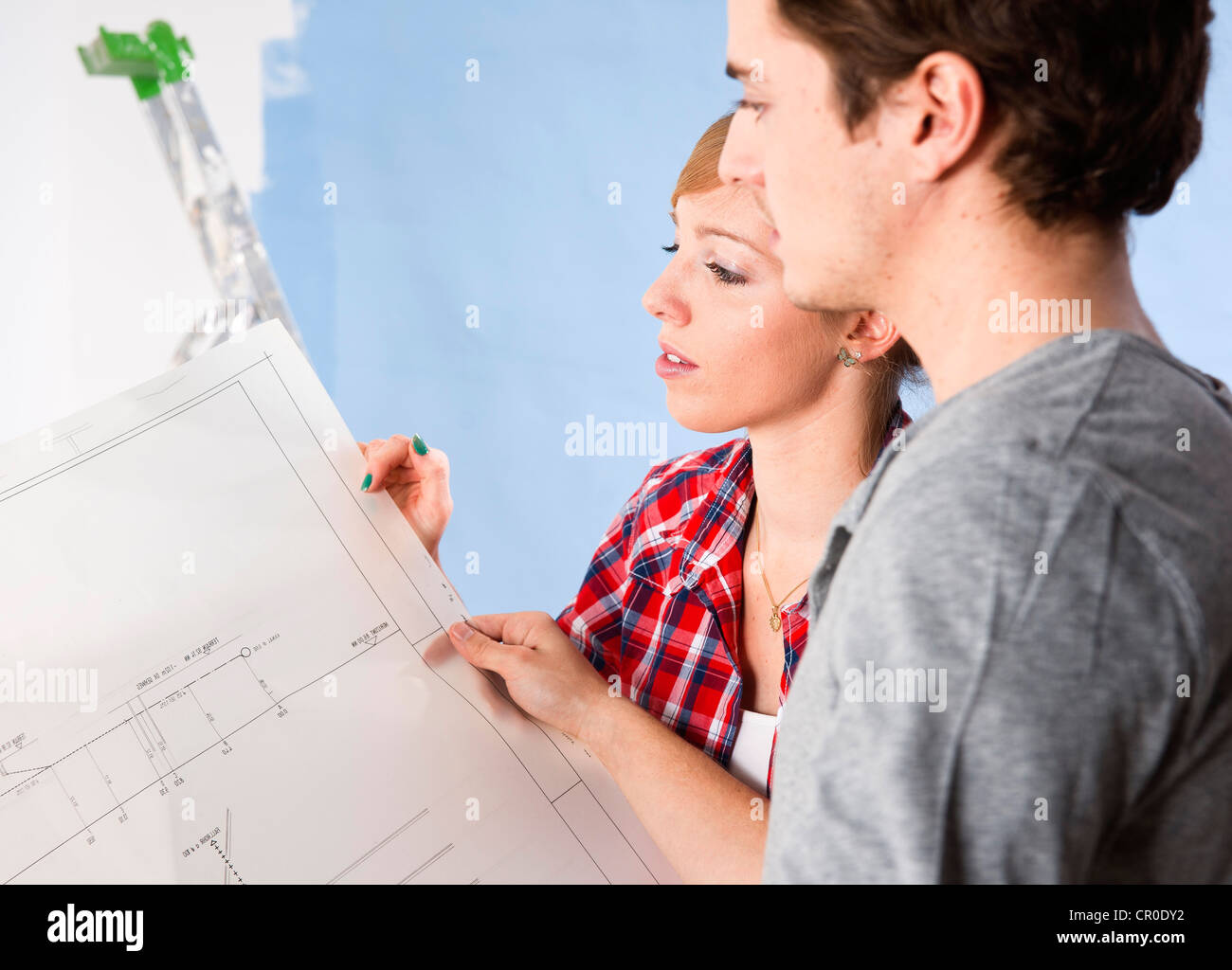 Young couple looking at a plan Stock Photo - Alamy