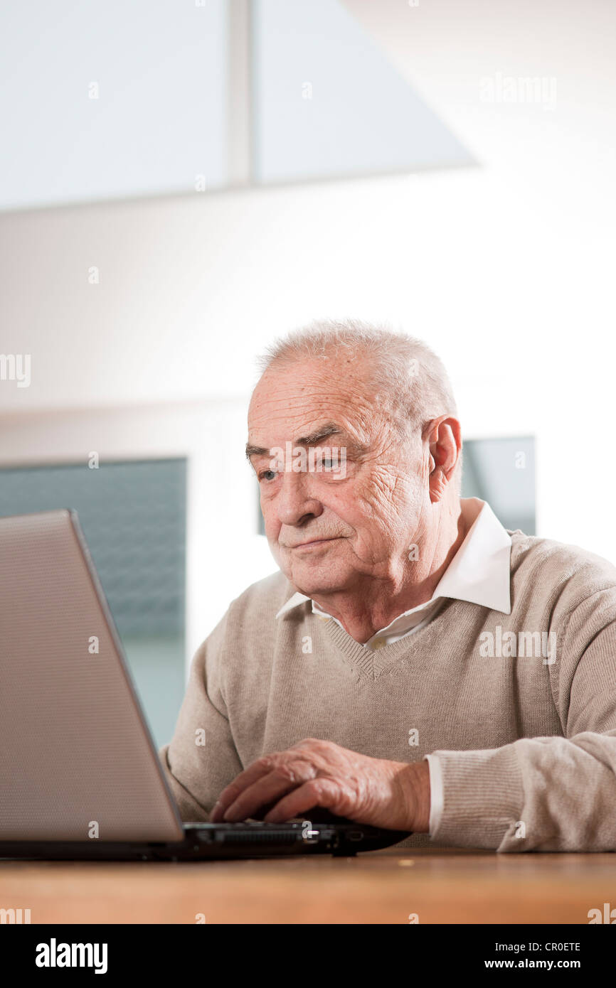 Elderly man using a PC Stock Photo - Alamy
