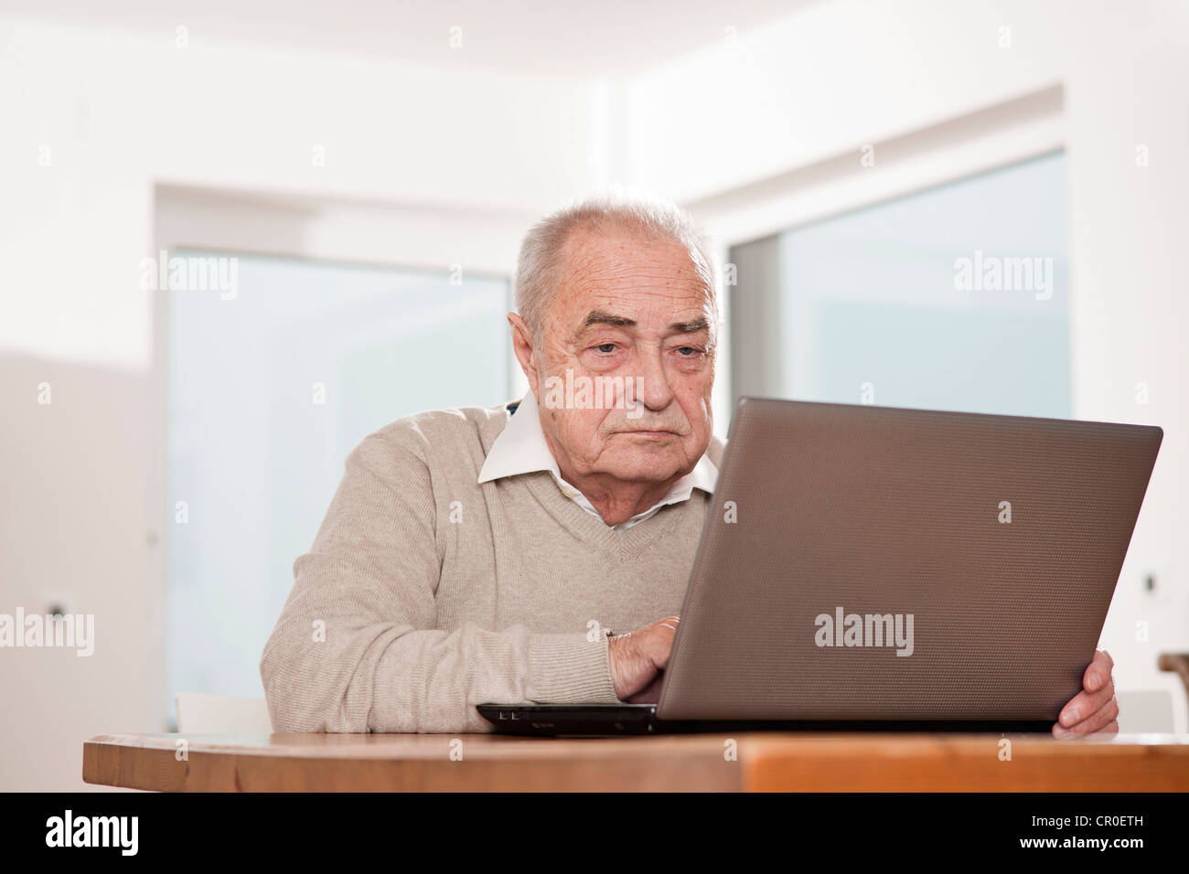 Elderly man using a PC Stock Photo - Alamy