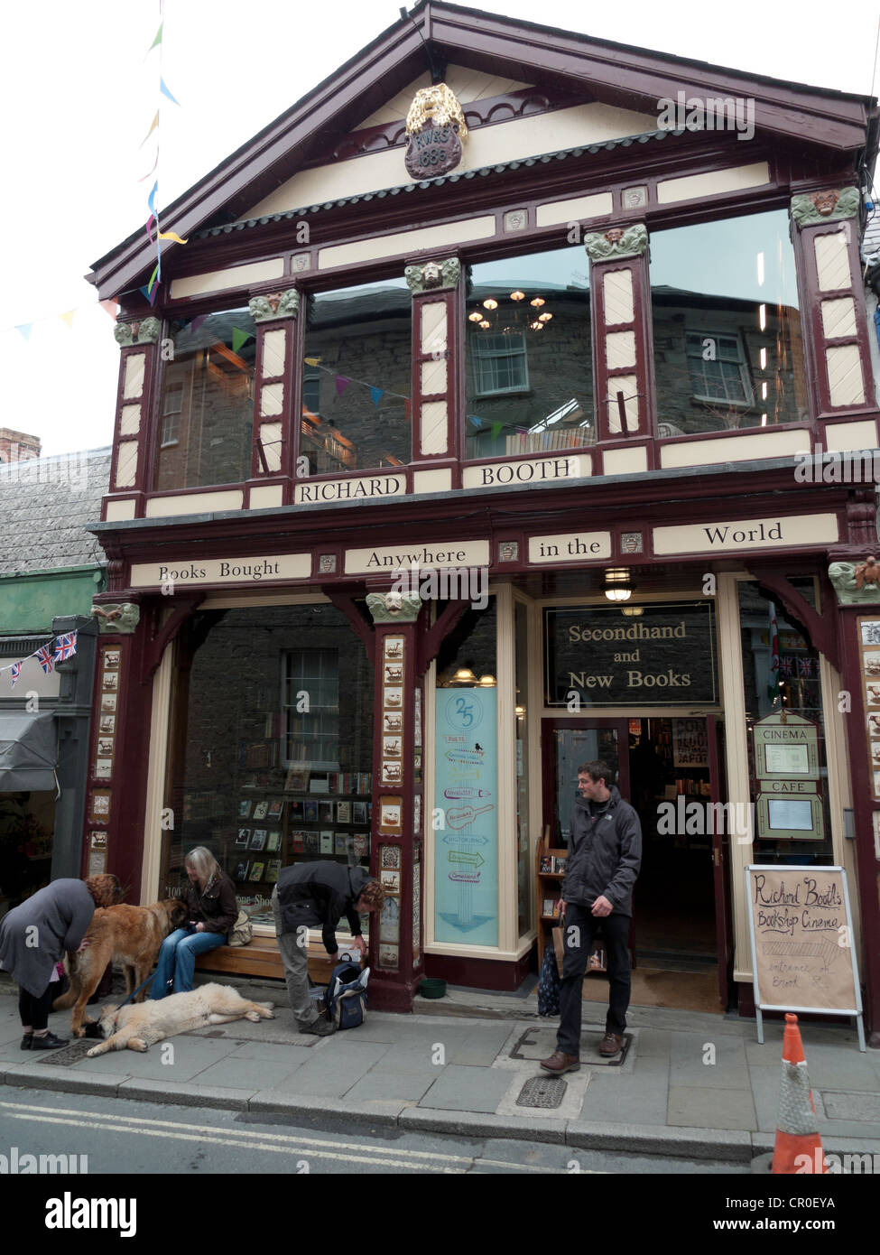 People and dogs outside Richard Booth bookstore book shop bookshop ...