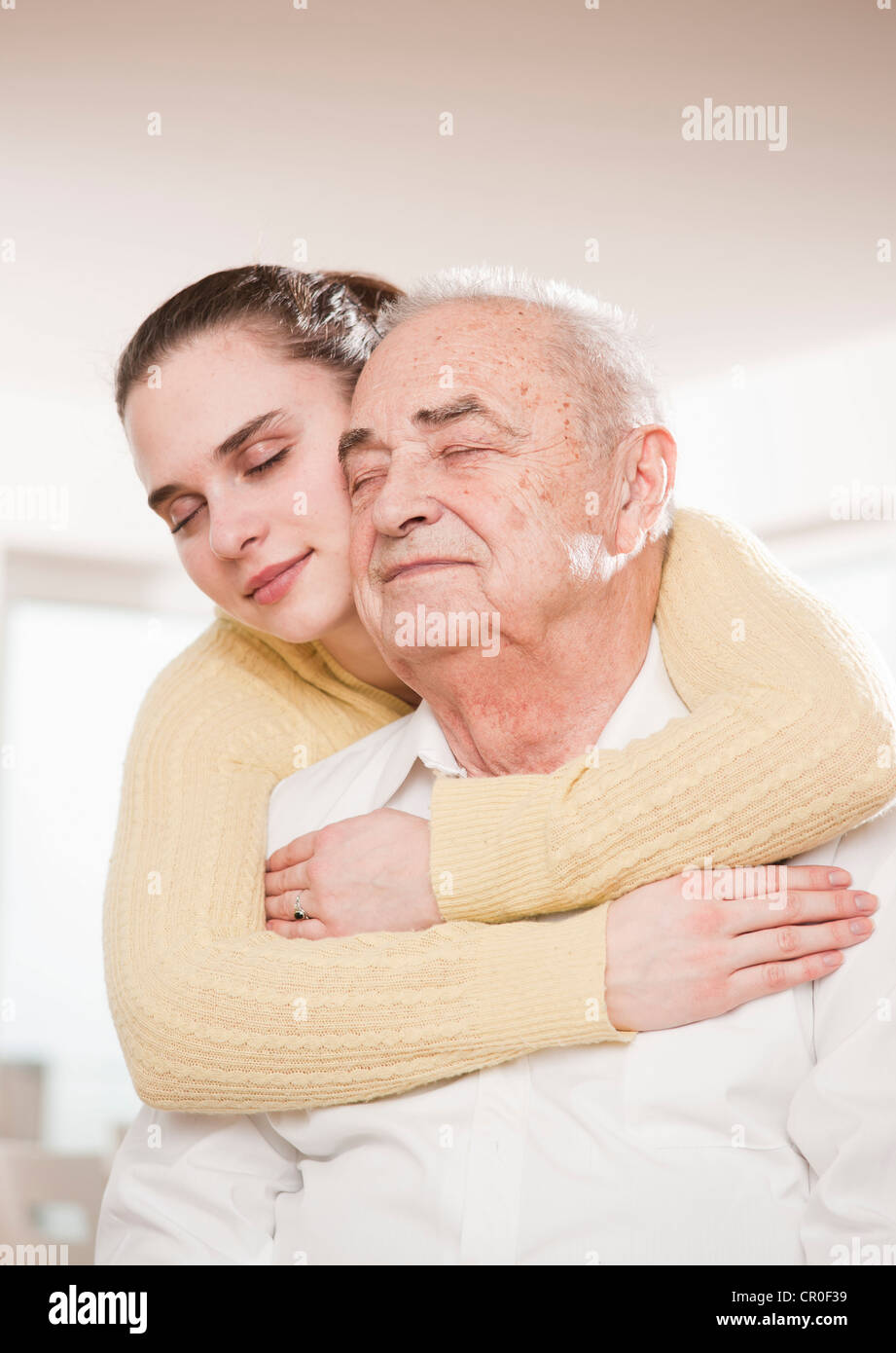 Young woman hugging an elderly man Stock Photo - Alamy