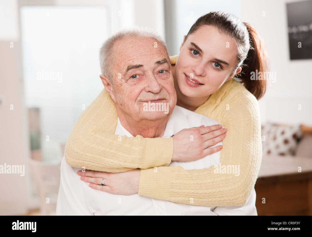 Young woman hugging an elderly man Stock Photo - Alamy