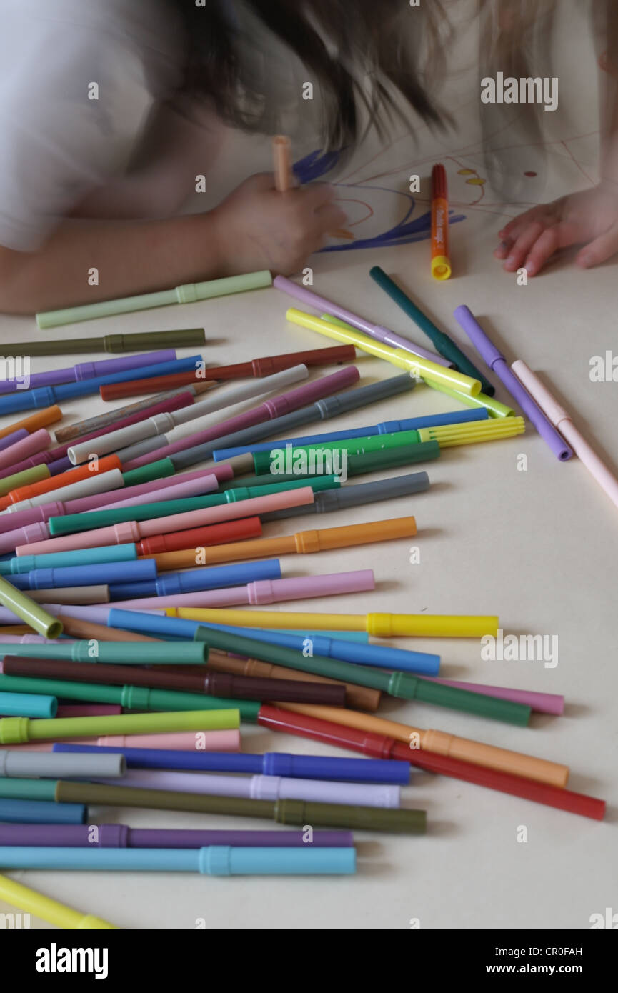 pre-school Child drawing on a paper with coloring pens Stock Photo - Alamy