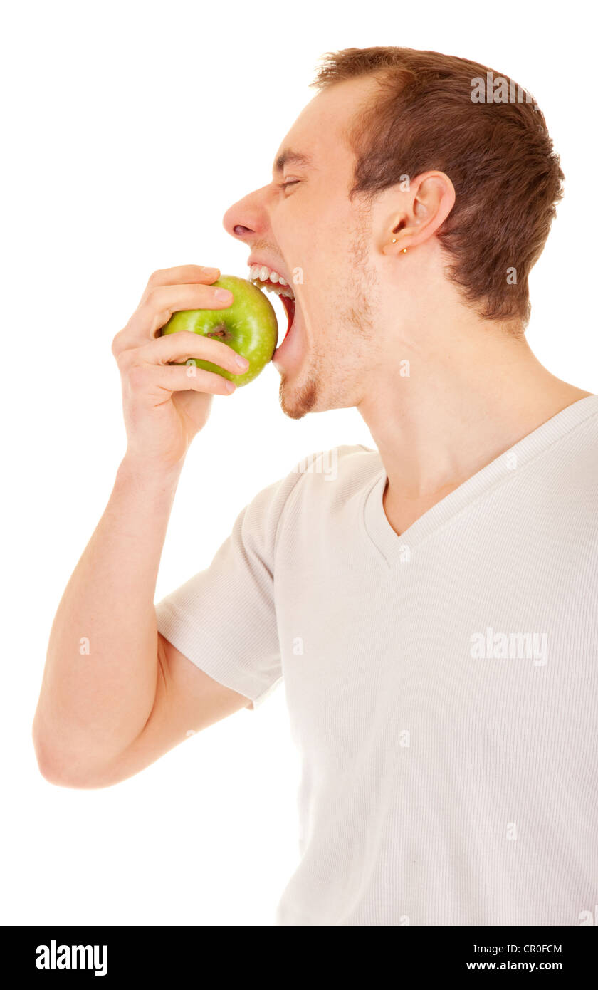 Young handsome man is biting a green apple on his palm. On white ...