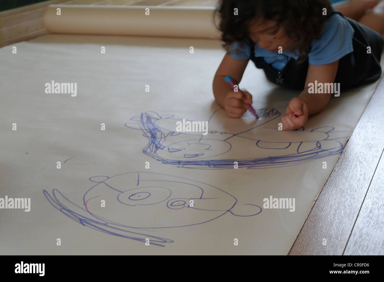 pre-school Child drawing on a paper with coloring pens Stock Photo - Alamy