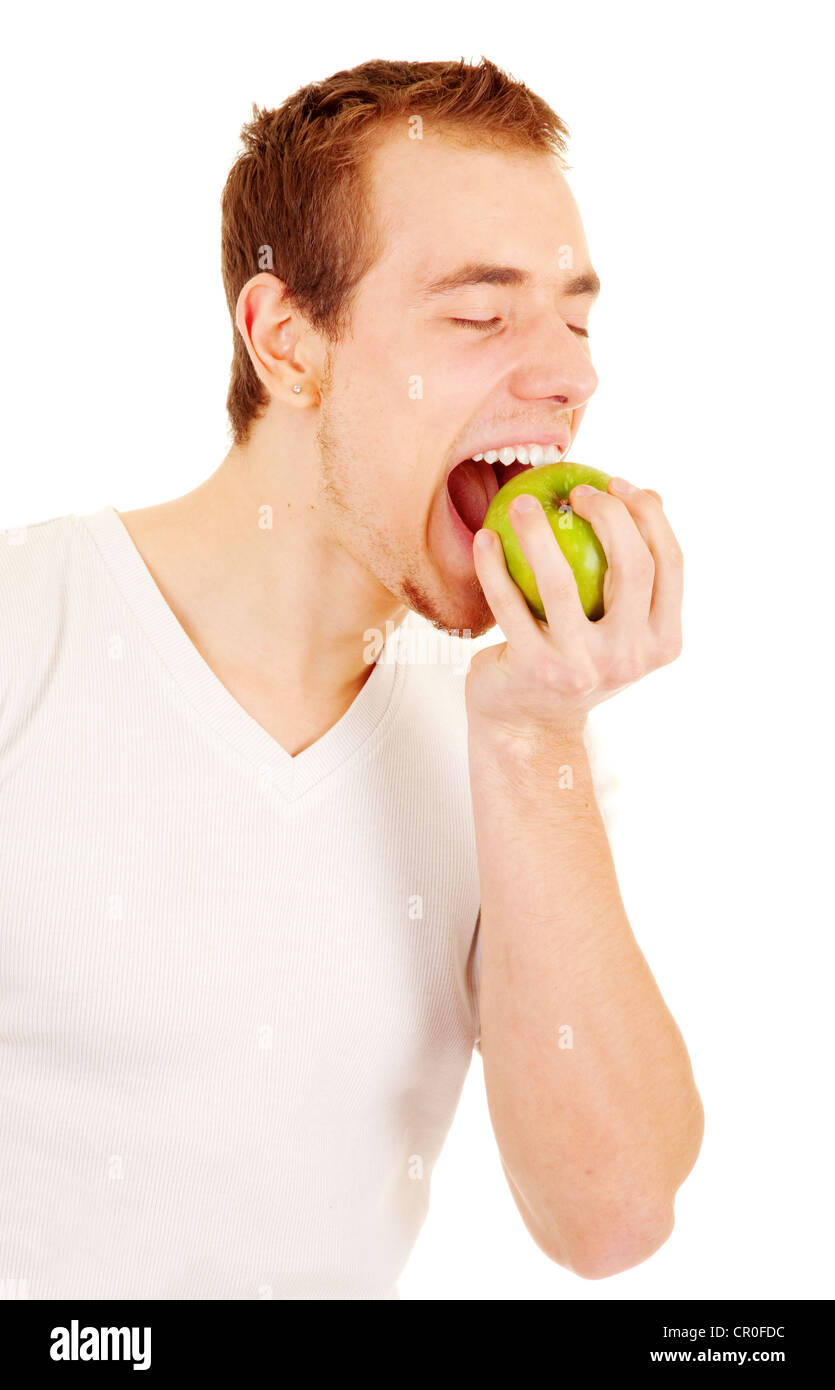 Young handsome man is biting a green apple on his palm. On white ...