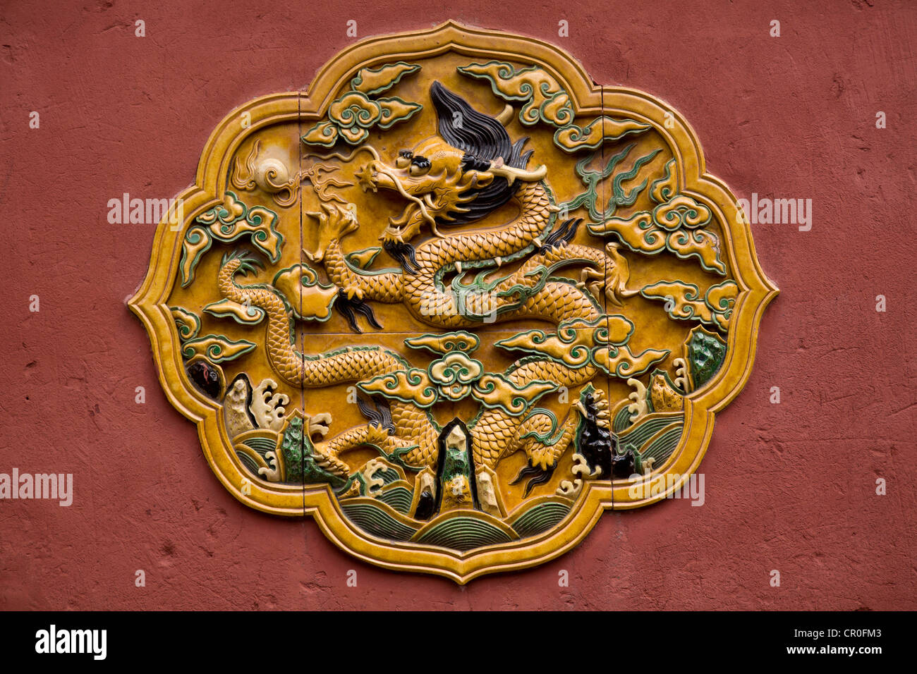 A traditional glazed ceramic wall motif decorates a wall in the ...