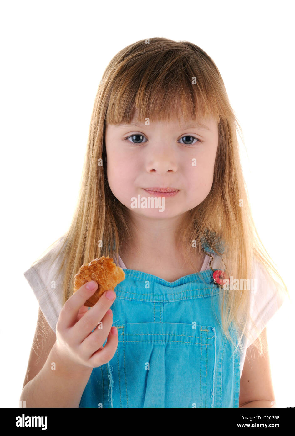Small beauty eating pie girl on white background Stock Photo - Alamy