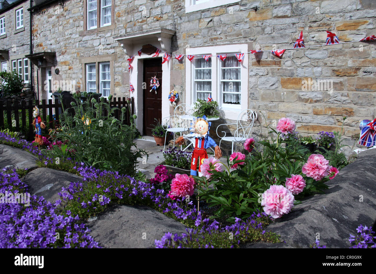 Peak District Cottage decorated for Well Dressing Week Stock Photo - Alamy