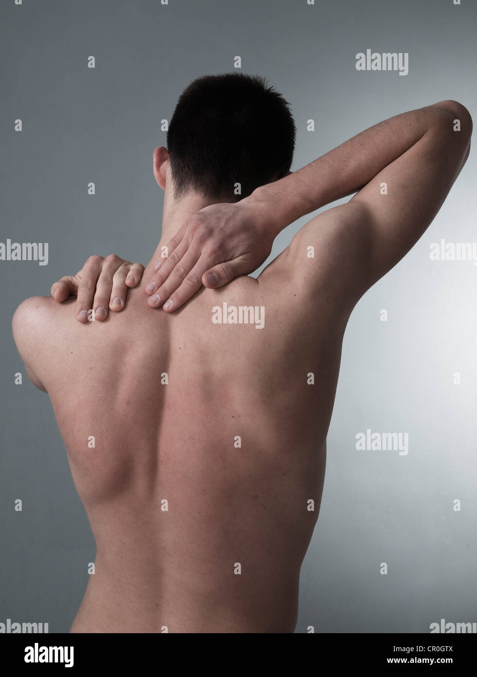 Young man with back pain, neck pain Stock Photo - Alamy