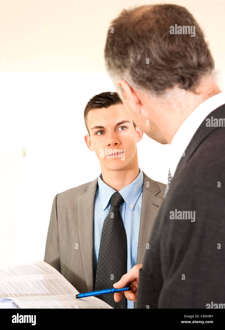 Boss controlling the contract of an employee Stock Photo - Alamy