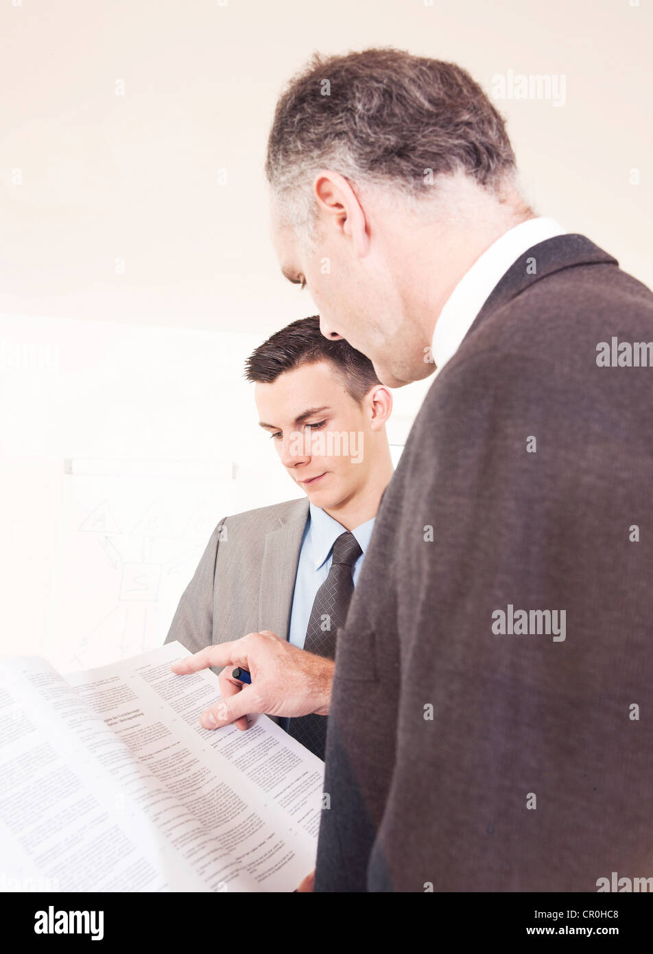 Boss controlling the contract of an employee Stock Photo - Alamy