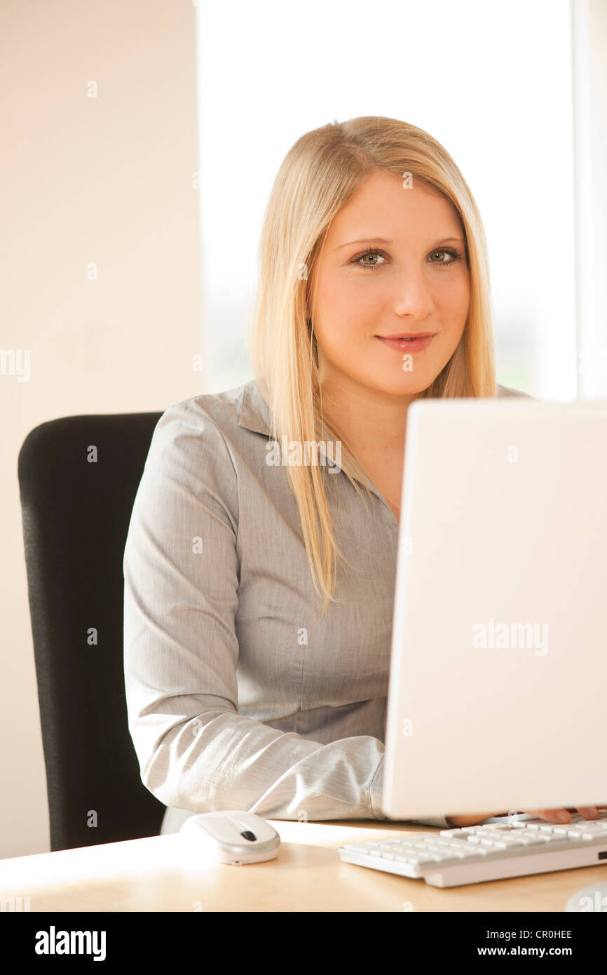 Young woman working on computer Stock Photo - Alamy