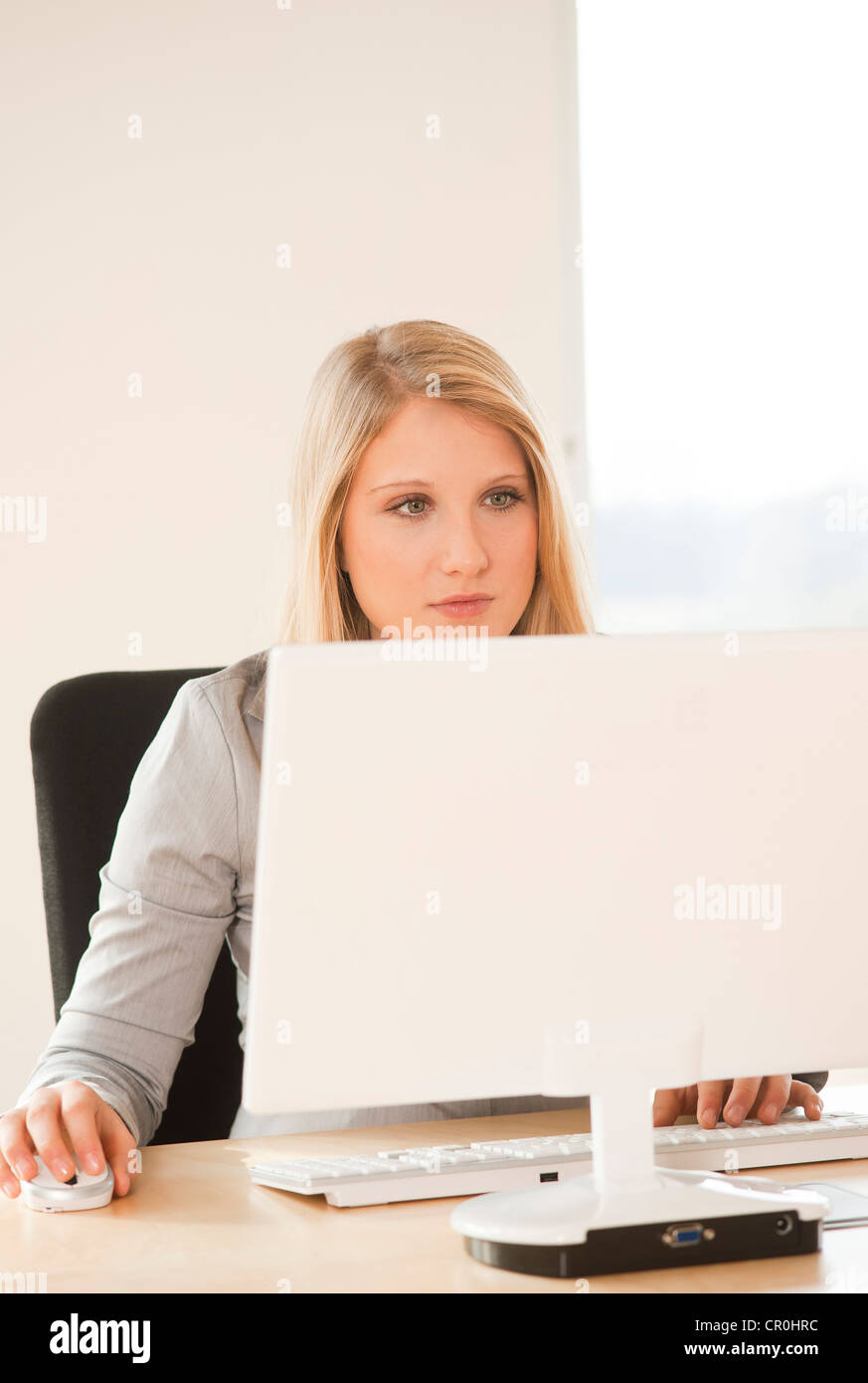 Young woman working on computer Stock Photo - Alamy
