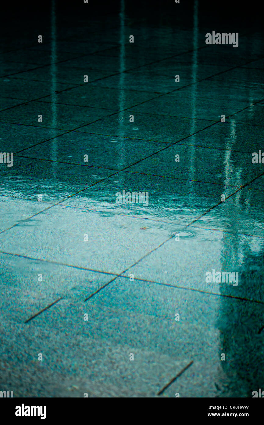 Rain on flagged floor Stock Photo - Alamy