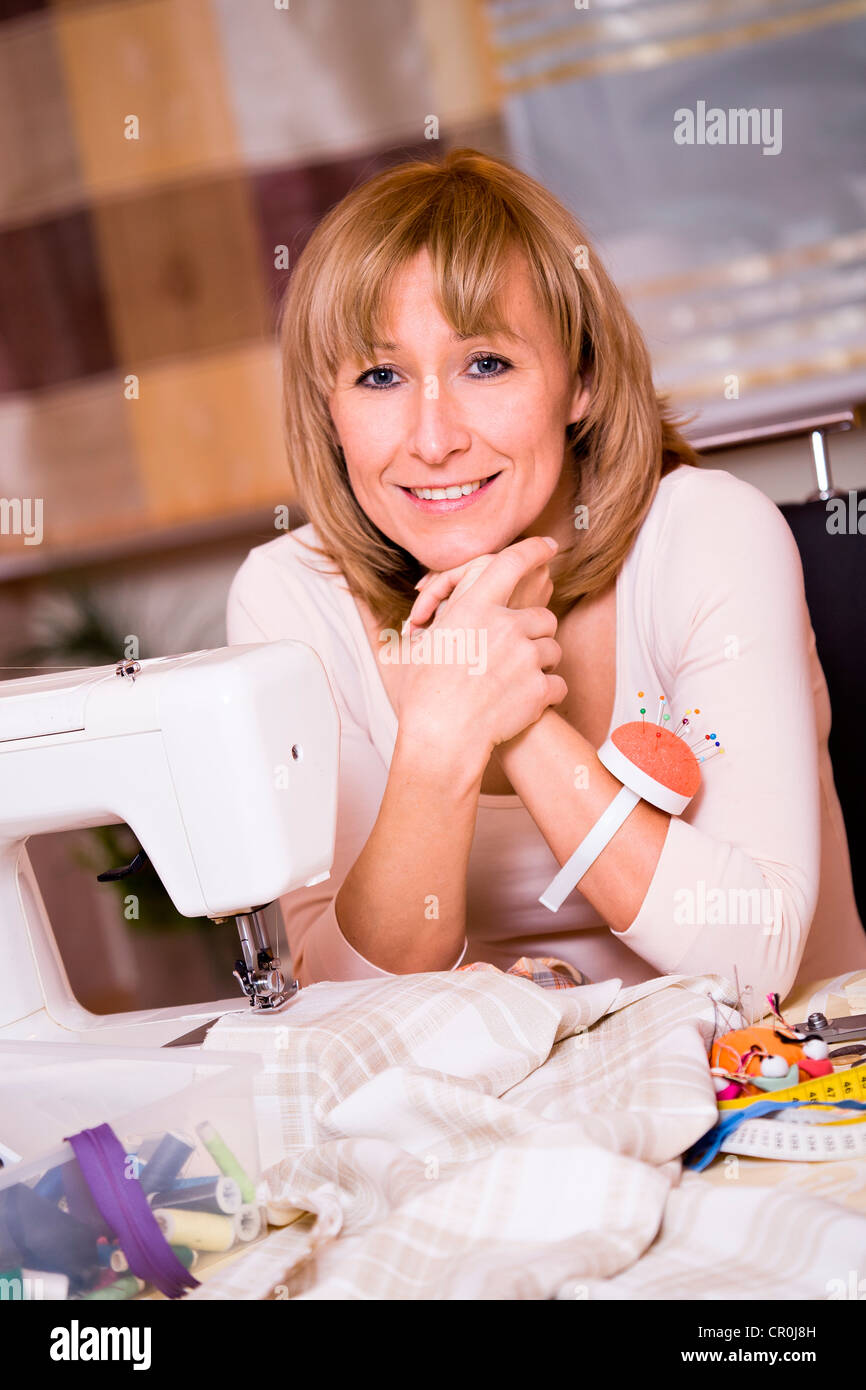 Woman with a sewing machine Stock Photo - Alamy