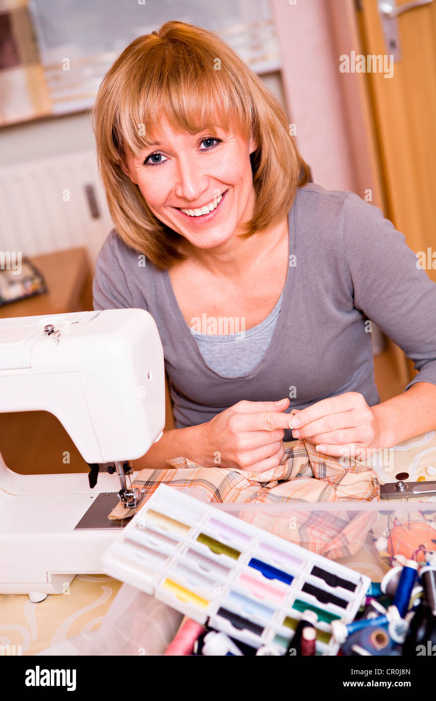Woman with a sewing machine Stock Photo - Alamy