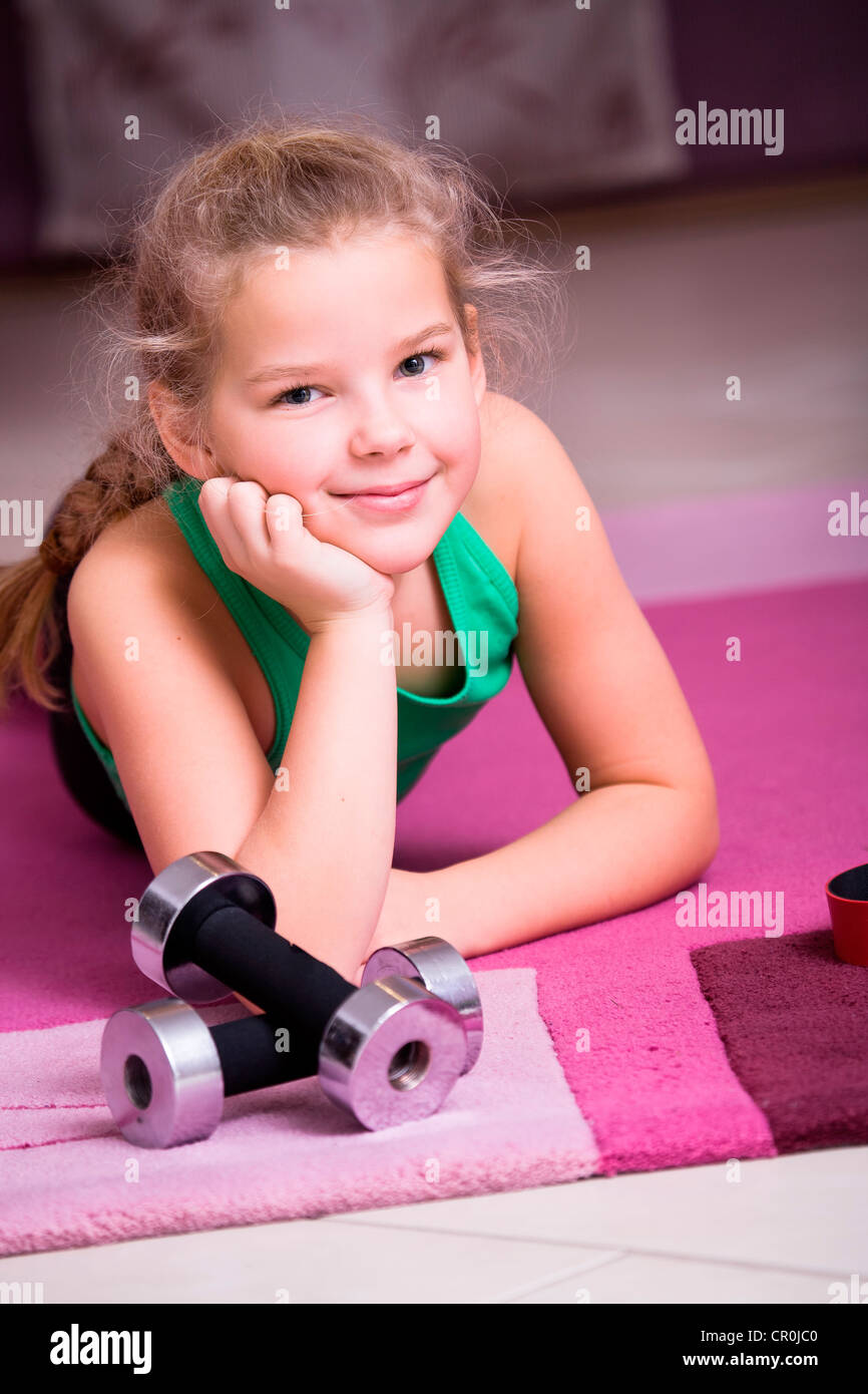 Girl, 8, exercising with small dumbbells Stock Photo - Alamy