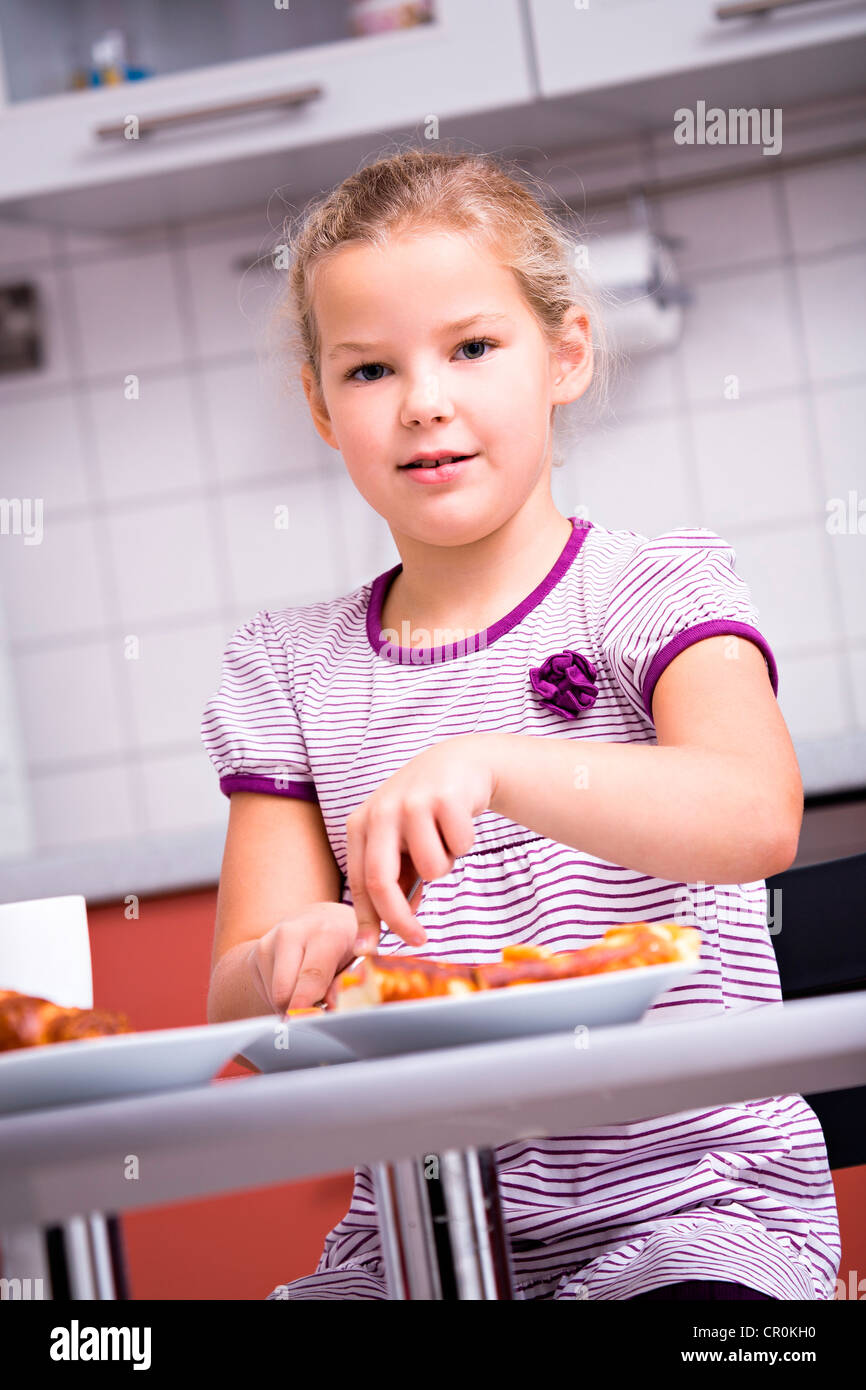 Young girl having breakfast in the kitchen Stock Photo - Alamy