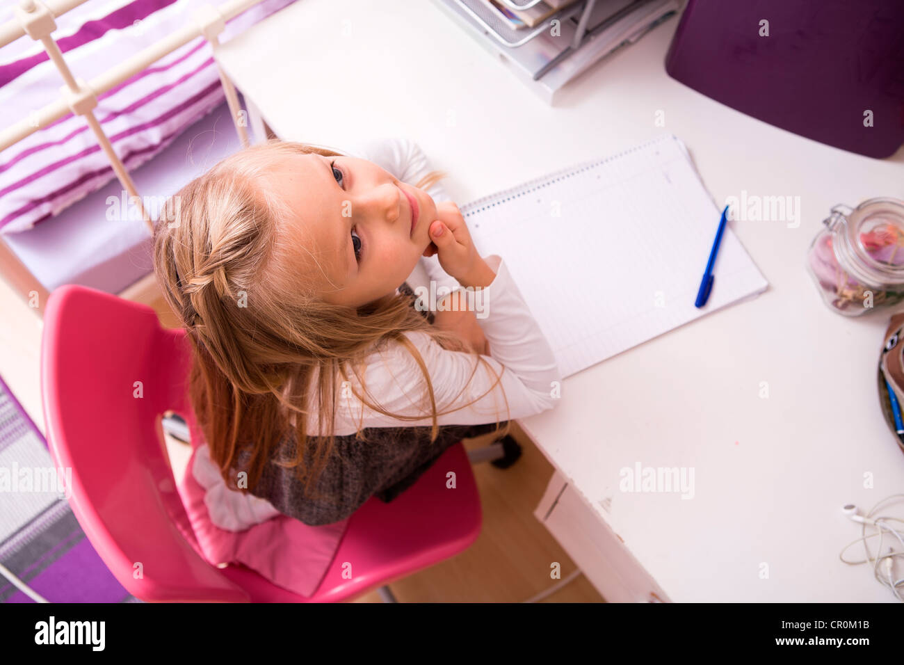 Girl, 9, seated at her desk Stock Photo - Alamy