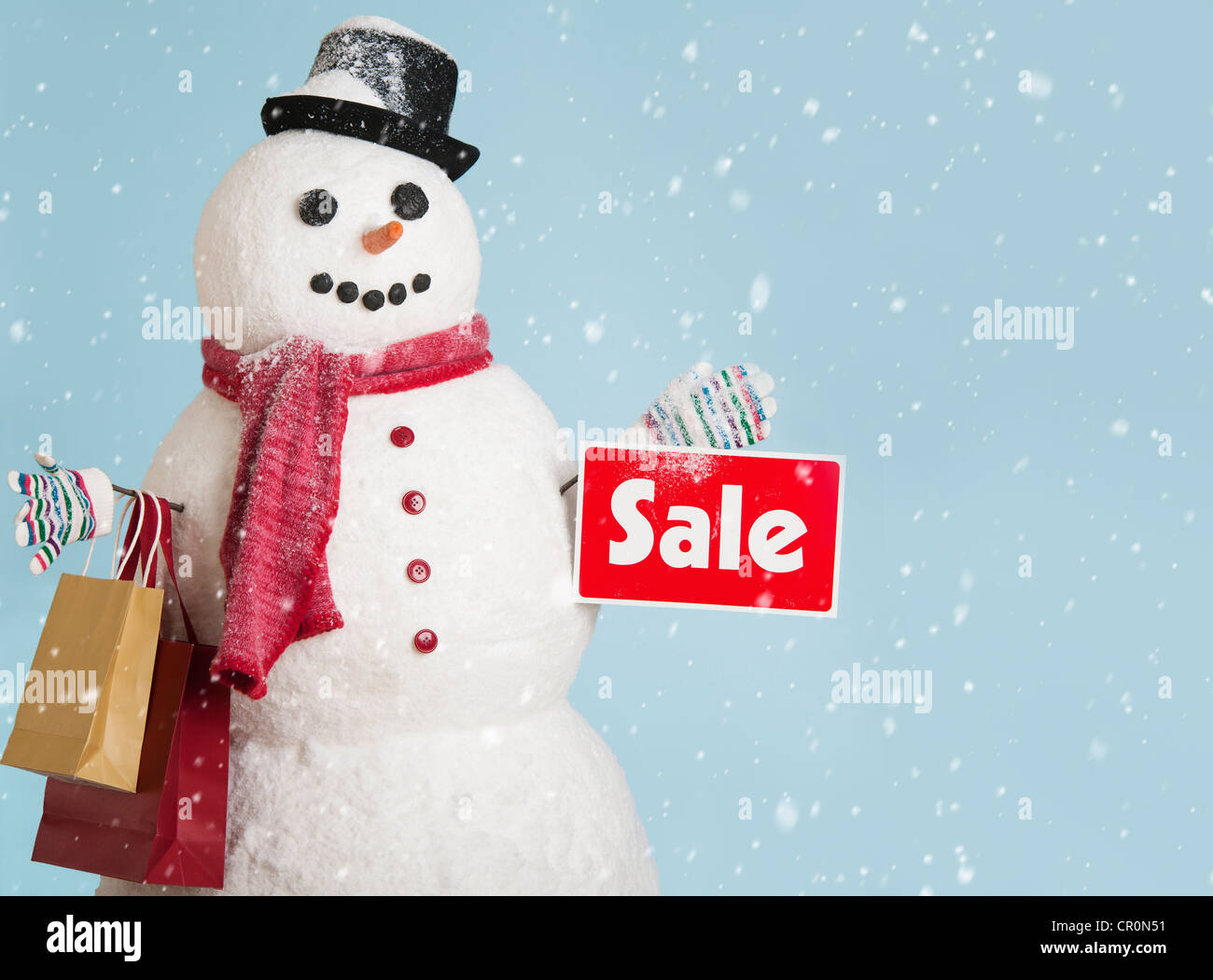 Studio shot of snowman with shoppings Stock Photo - Alamy