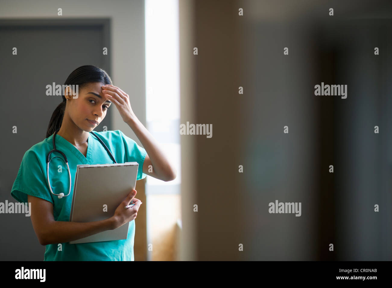 USA, New Jersey, Jersey City, Female nurse with head in hands Stock ...