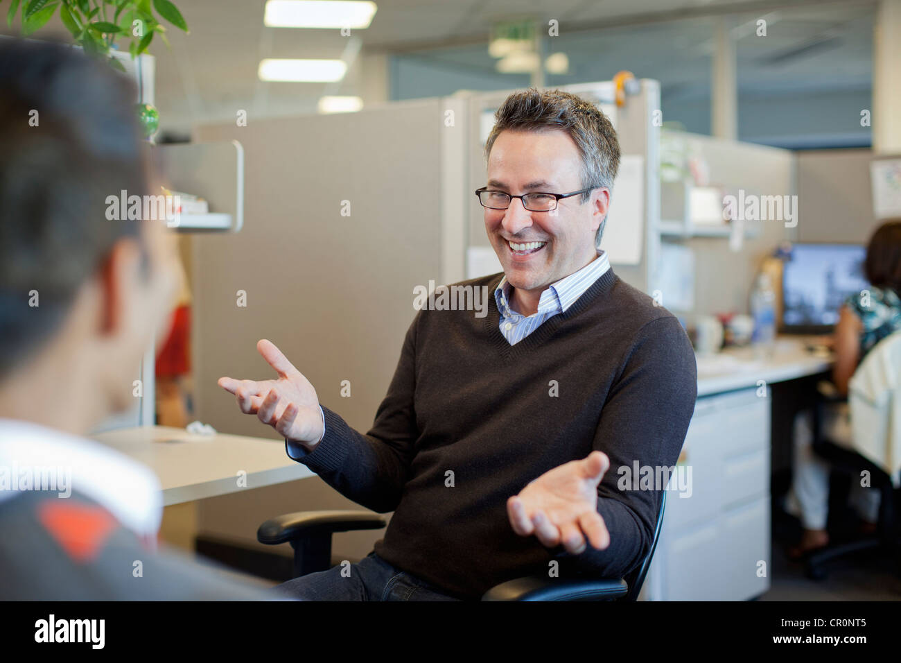 Business people talking in office cubicle Stock Photo - Alamy