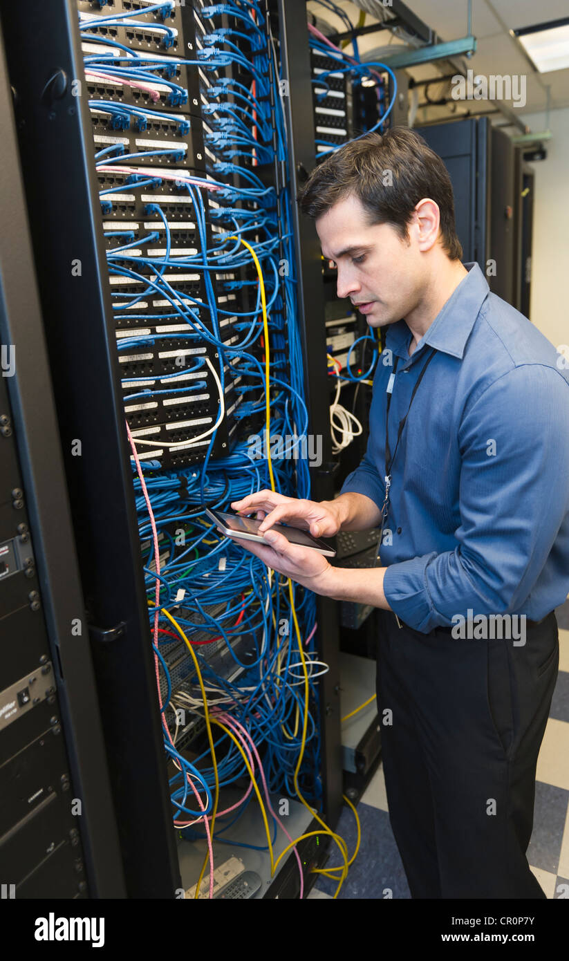 USA, New York, New York City, Technician inspecting network server ...