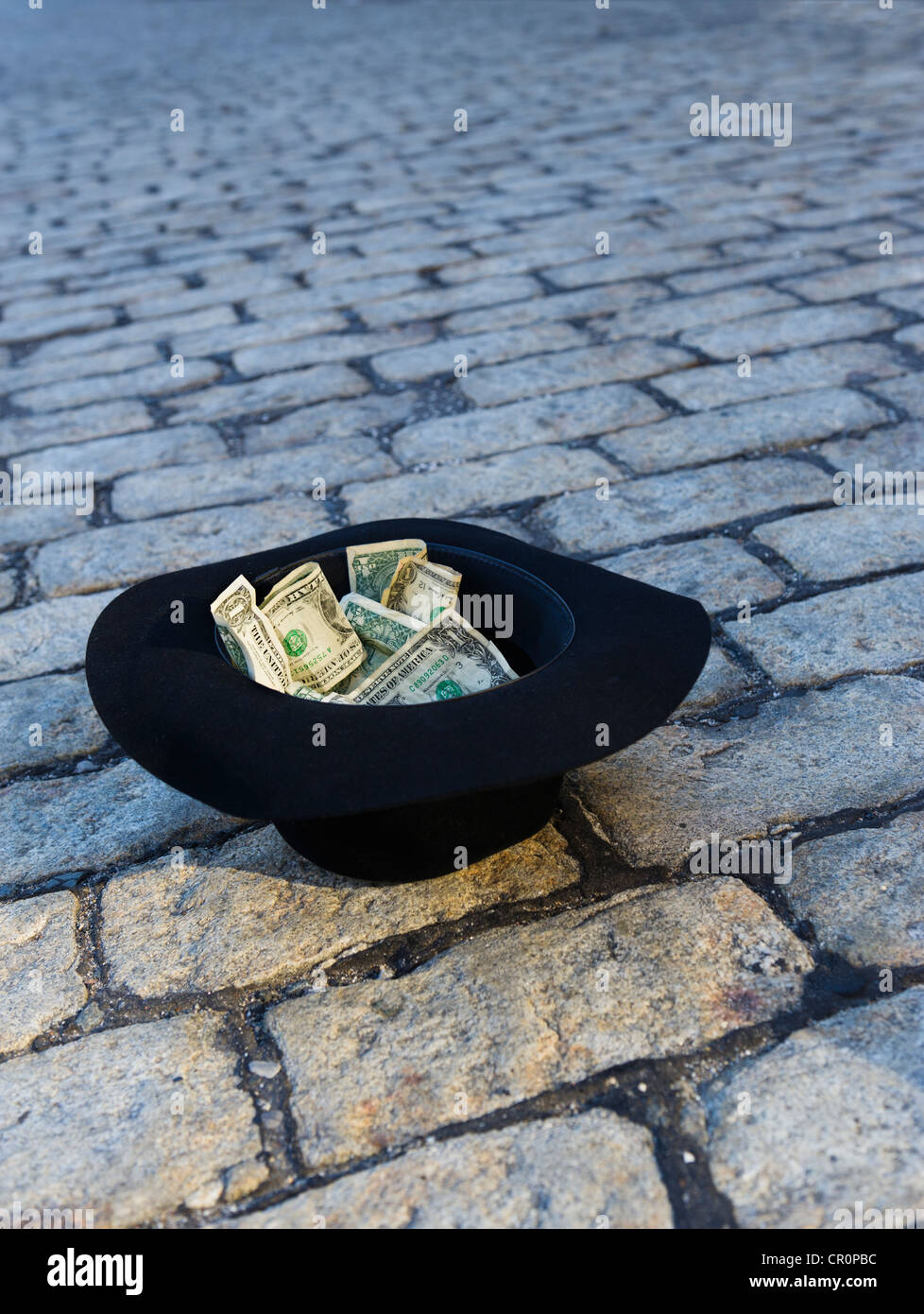 Money in hat on cobblestone street hi-res stock photography and images ...