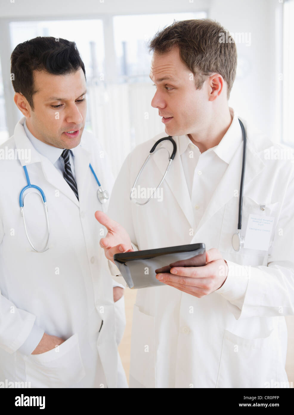 Doctors using digital tablet together Stock Photo - Alamy