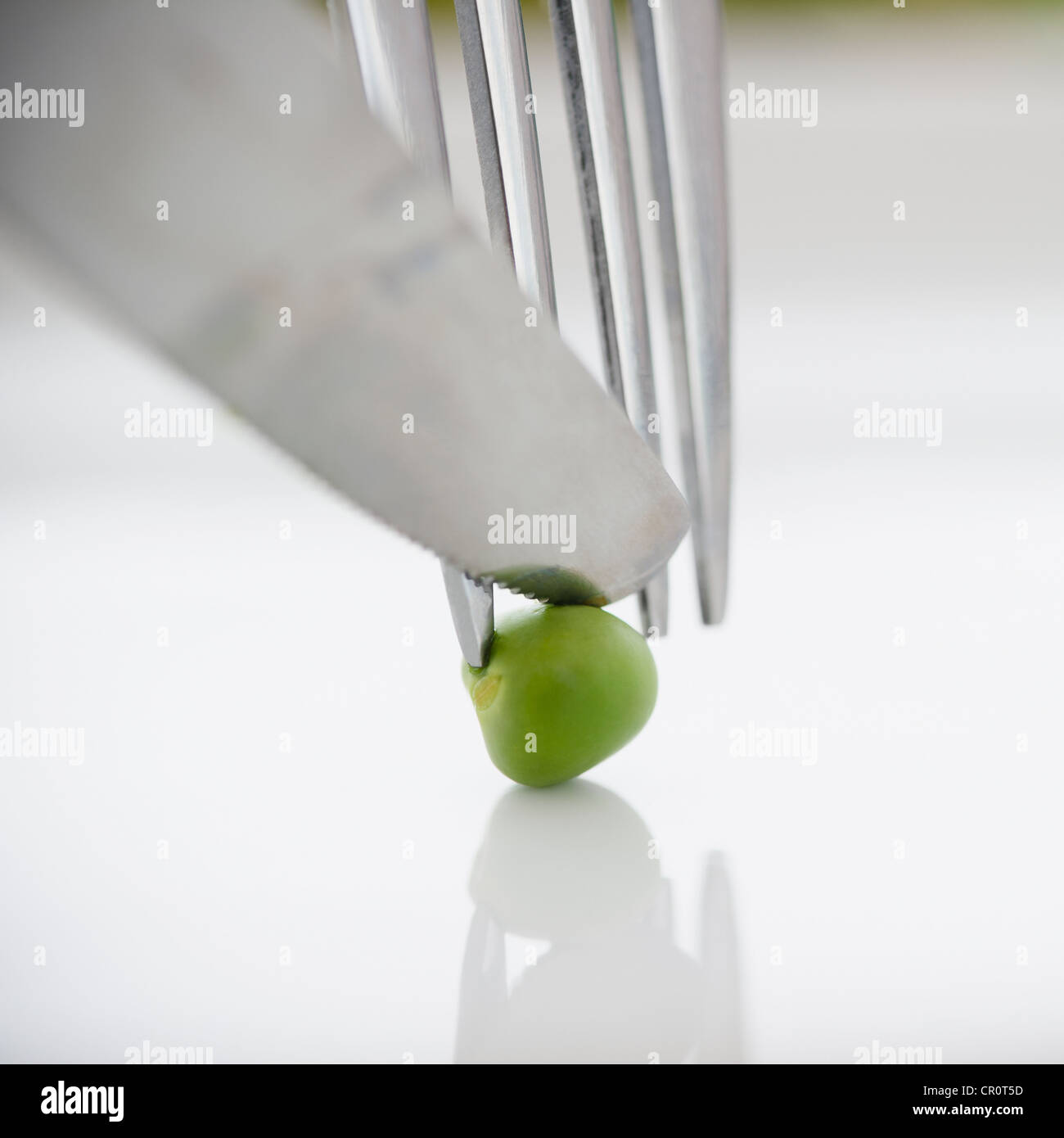 Close up of knife, fork and green pea, studio shot Stock Photo - Alamy
