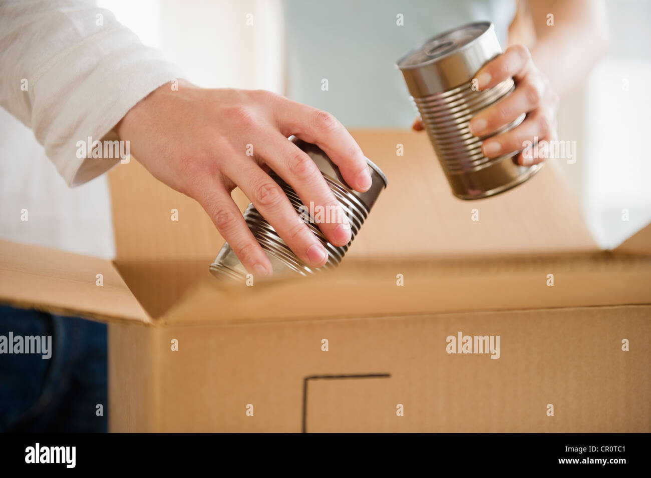 Two hand cans hi-res stock photography and images - Alamy