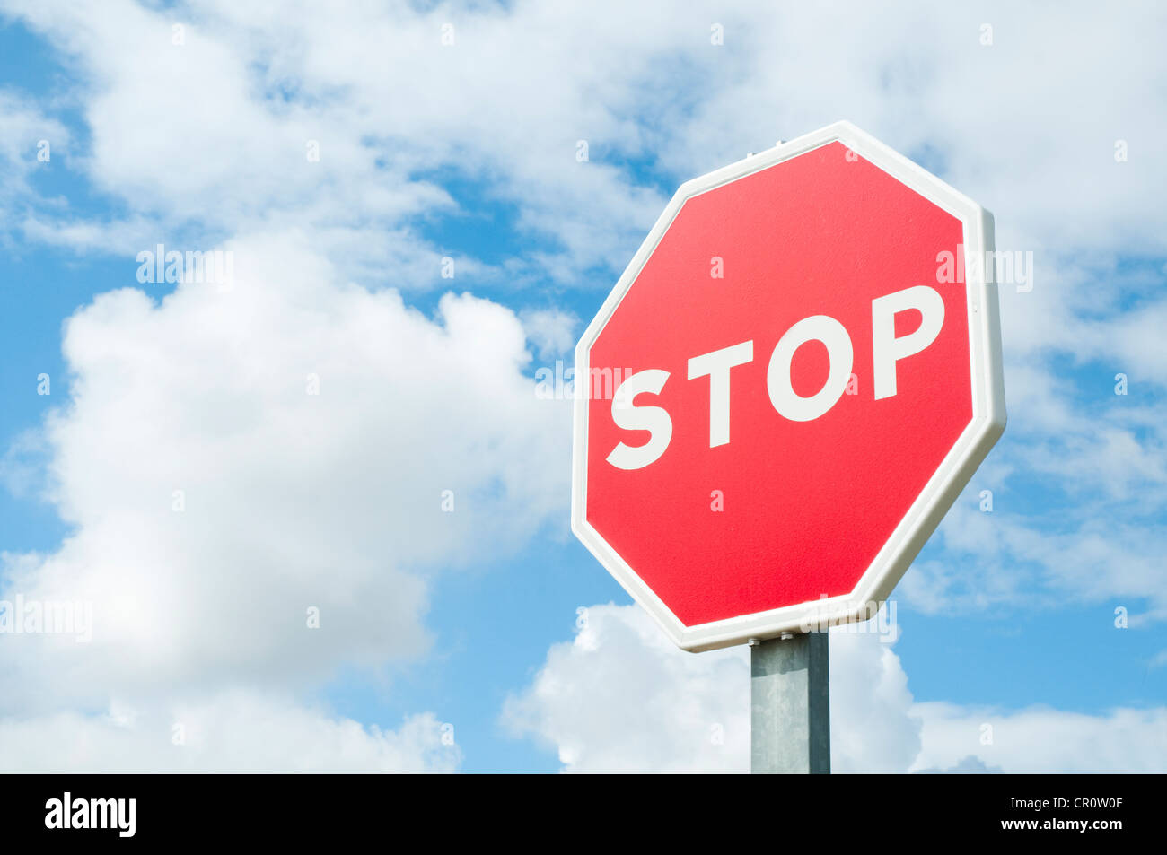 Stop traffic sign against blue and cloudy sky Stock Photo - Alamy
