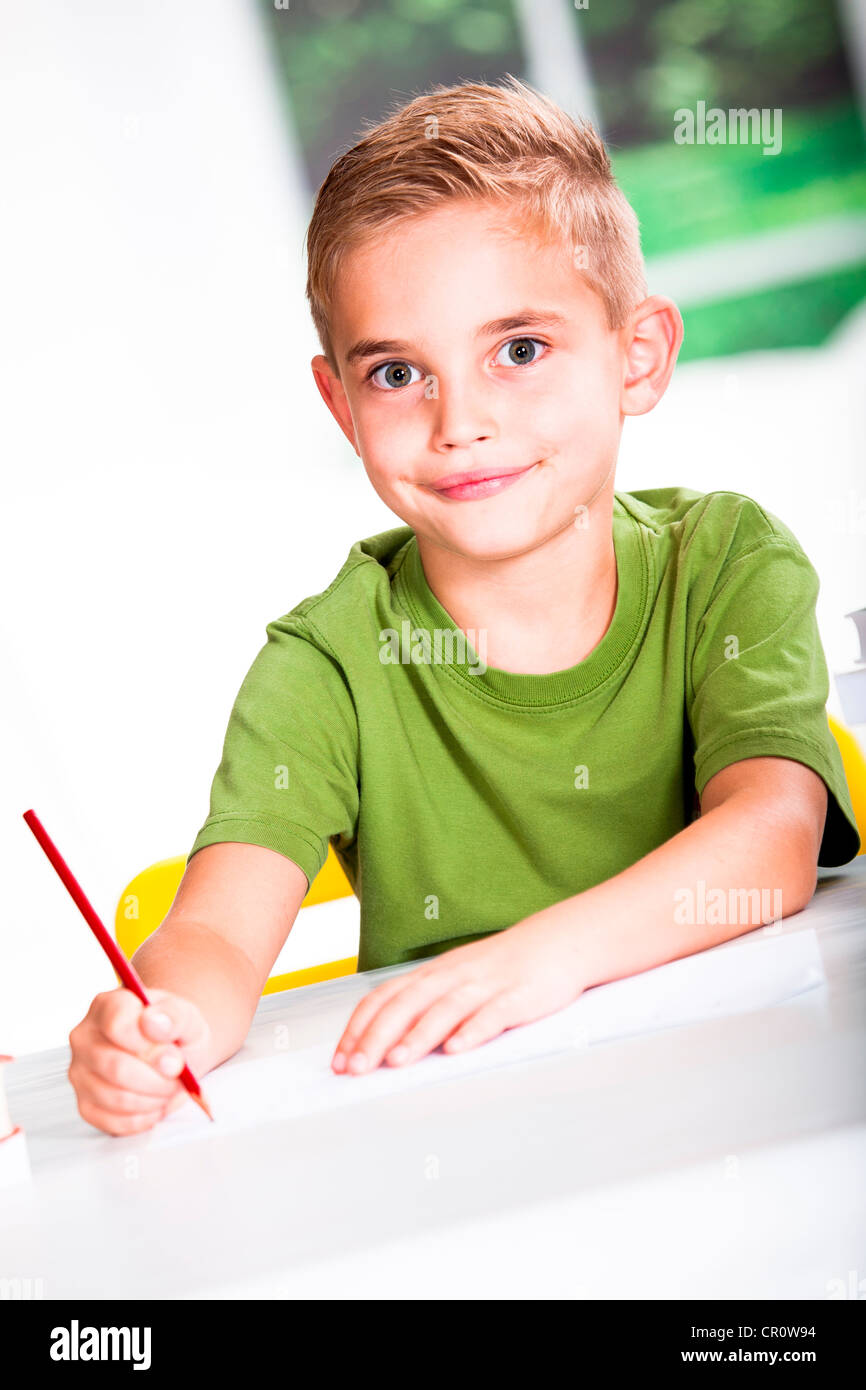 Boy with a sketch-pad at a table Stock Photo - Alamy