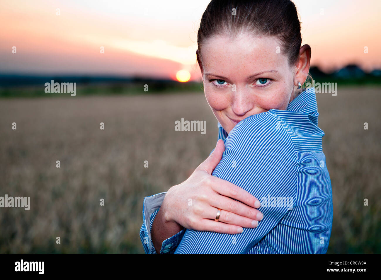 Young woman looking over her shoulder, portrait, outdoors Stock Photo ...