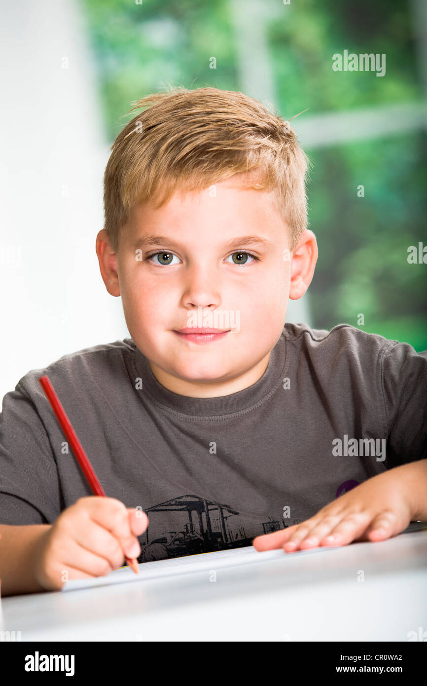 Boy with a sketch-pad at a table Stock Photo - Alamy