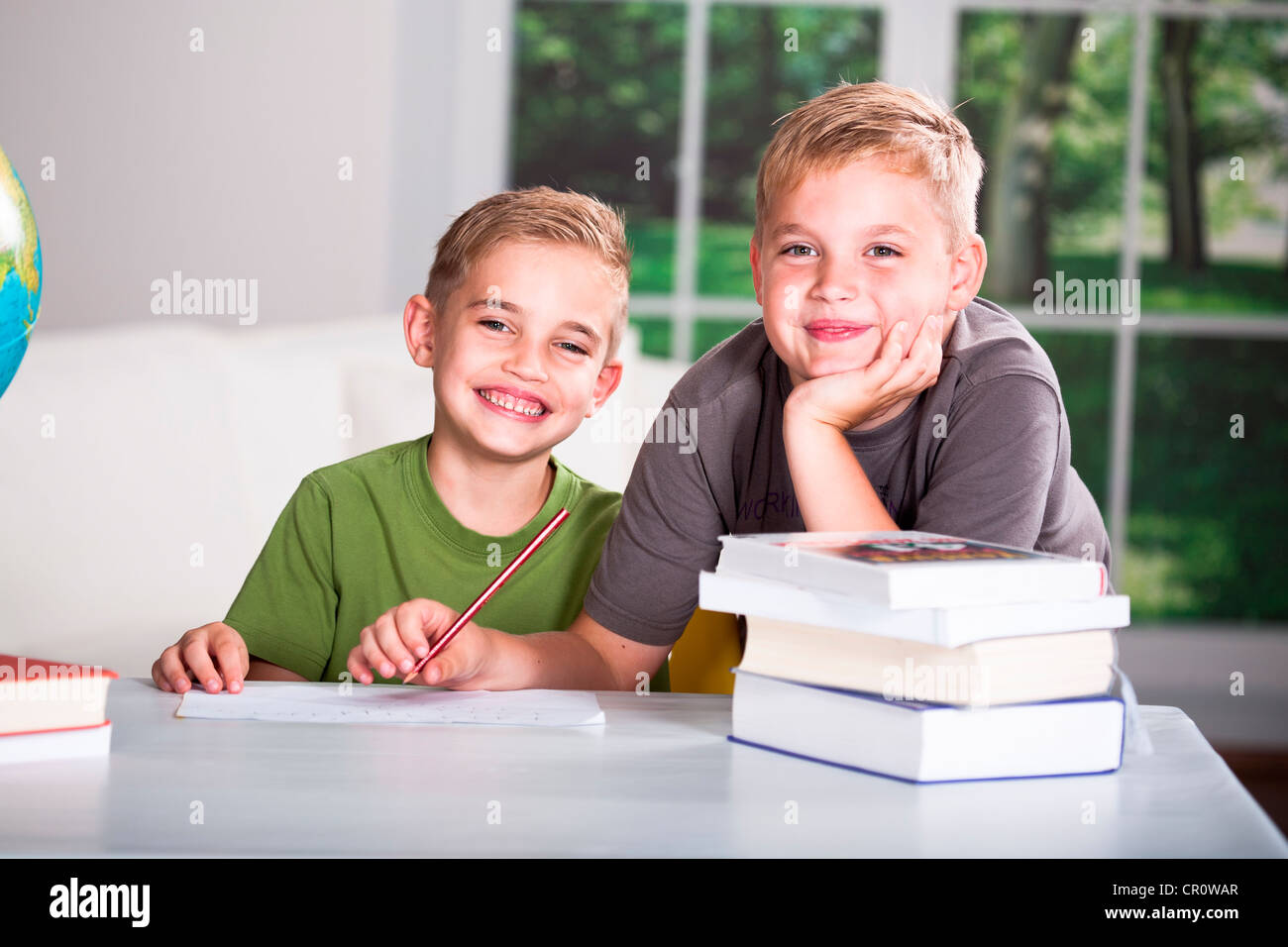Boy helping his younger brother doing the homework Stock Photo - Alamy