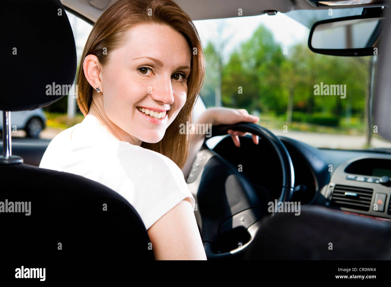 Young woman driving a car Stock Photo - Alamy
