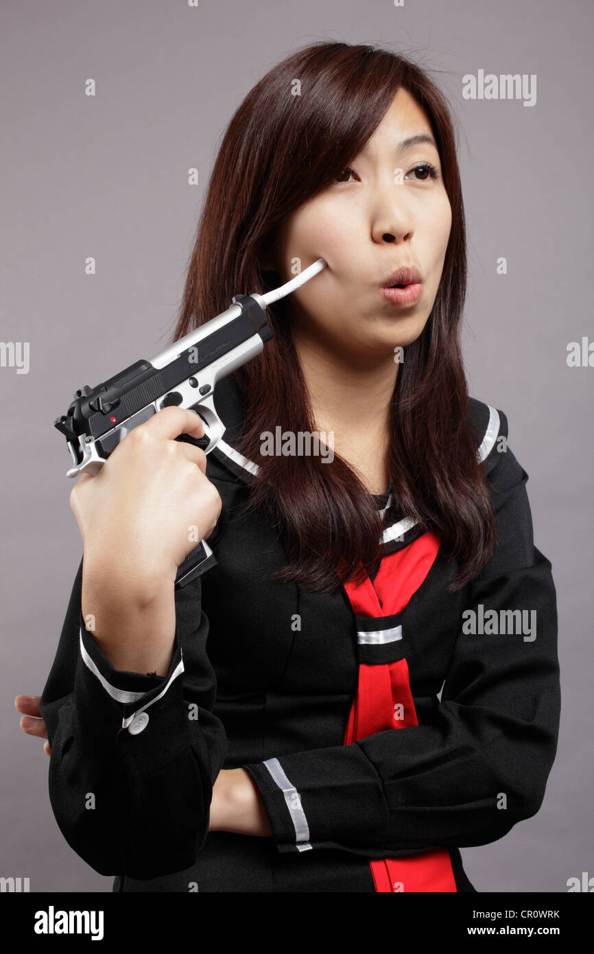 School girl plays cigarette and gun Stock Photo - Alamy